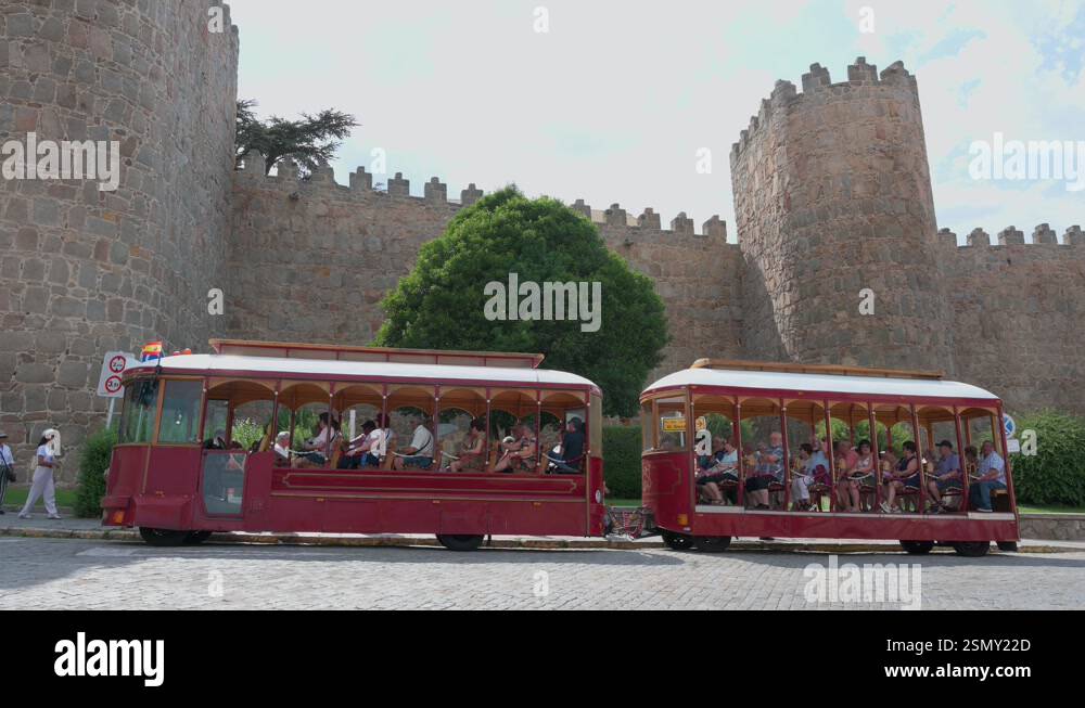 Avila, Spain - 07/26/2024: Visitors enjoy a guided bus tour of Ávila ...