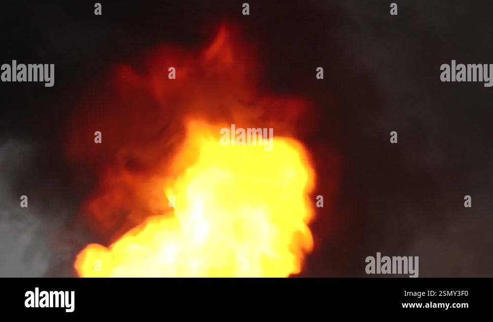A large, intense flame is visible burning within a furnace, seen ...