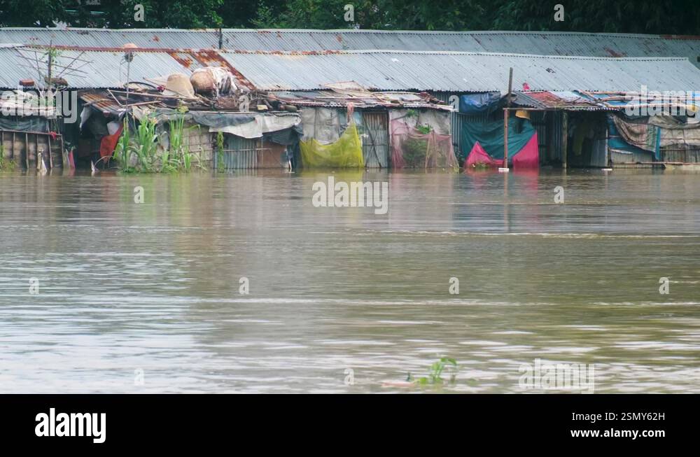 Overflowing flood water and submerged slum houses, poverty and Stock ...