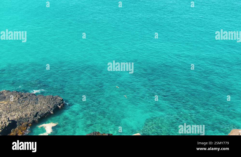 Calm turquoise water by rocky shore at Makapu’u Lookout at Oahu, Hawaii ...