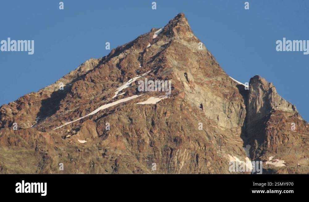 Close up slide over the sunset lit summit of Monte Rosa. Europes second ...