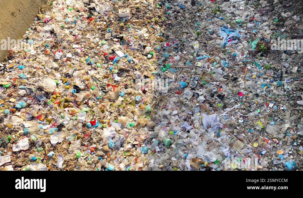 A dry canal clogged with landfill and pollution in the city of Dhaka ...