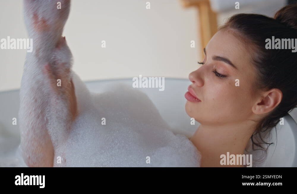 Relaxed woman enjoying bath morning routine closeup. Calm lady washing ...