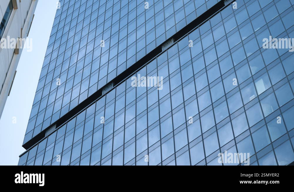 Close-up high rise skyscraper glass facade windows grid in downtown ...