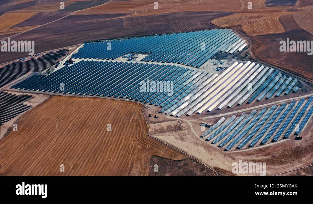 A breathtaking aerial view of a large-scale solar farm in a dry ...