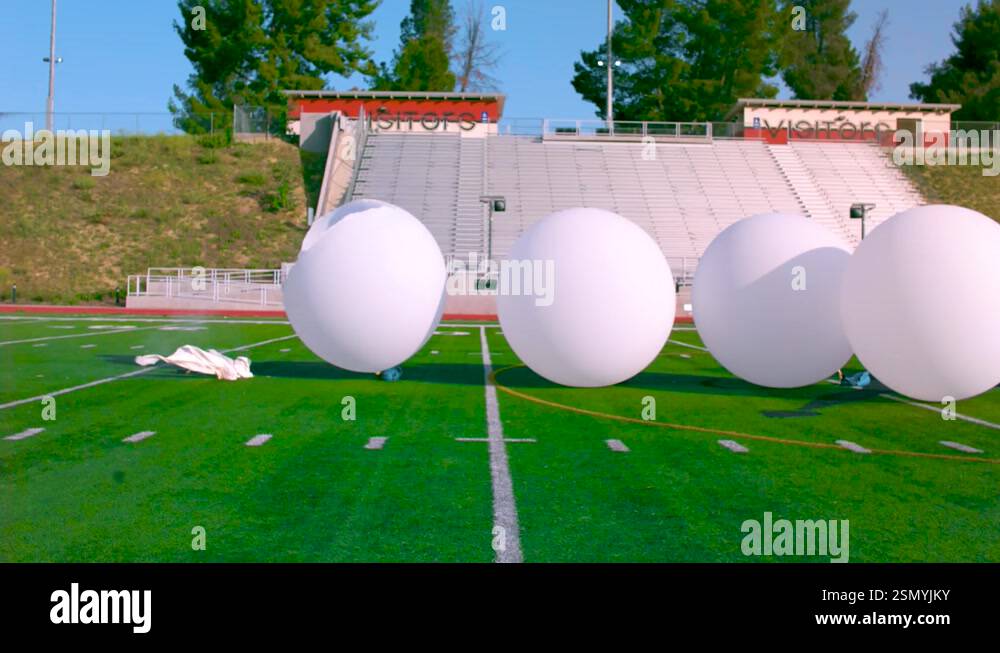Big white balloons filled with air being crushed by an American ...