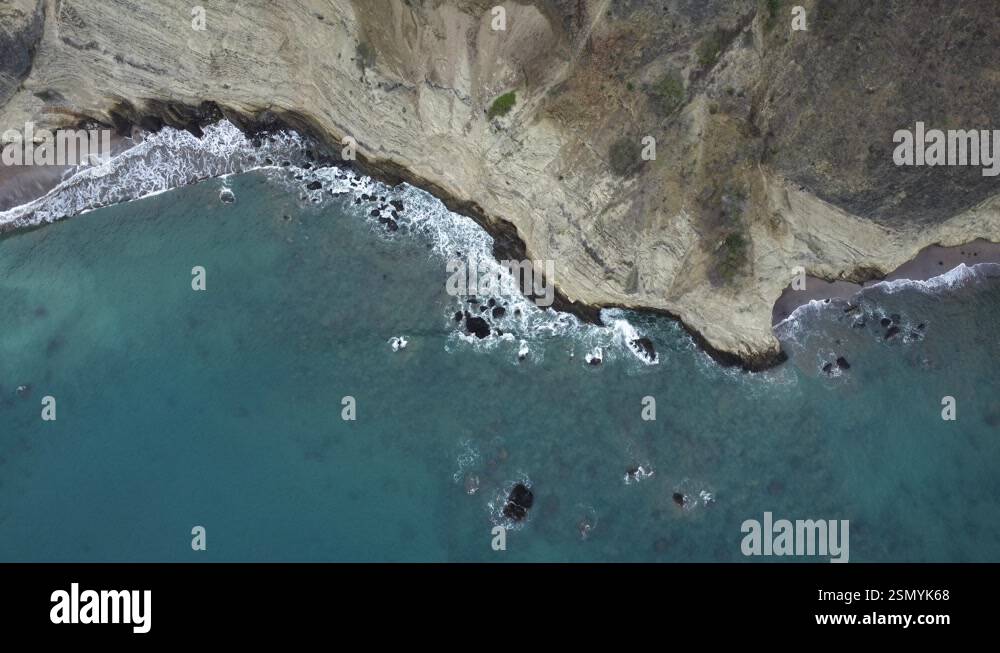 Coastline cliff in Manabi, Ecuador Pacific Ocean, top-down aerial wave ...