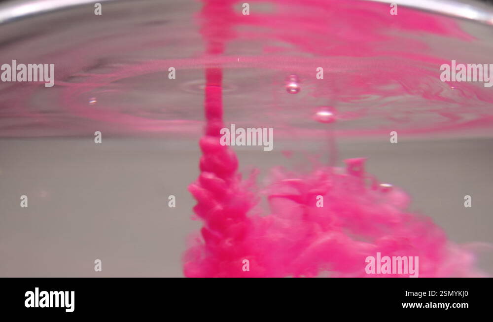 Magenta Paint Pouring into Water Stock Video Footage - Alamy