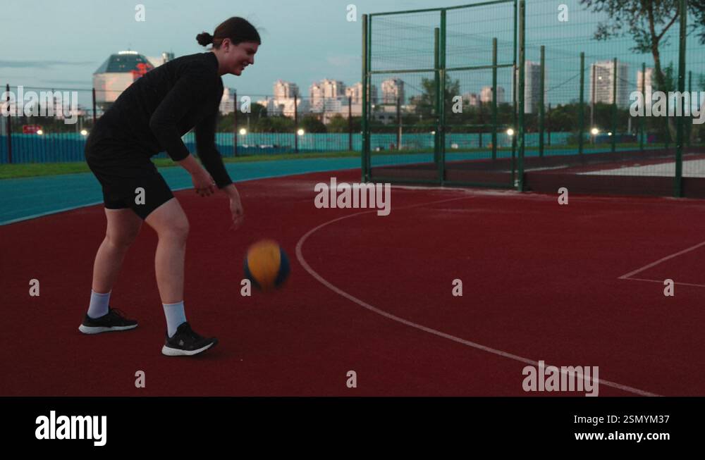 young girl basketball player training and exercising outdoors on the ...