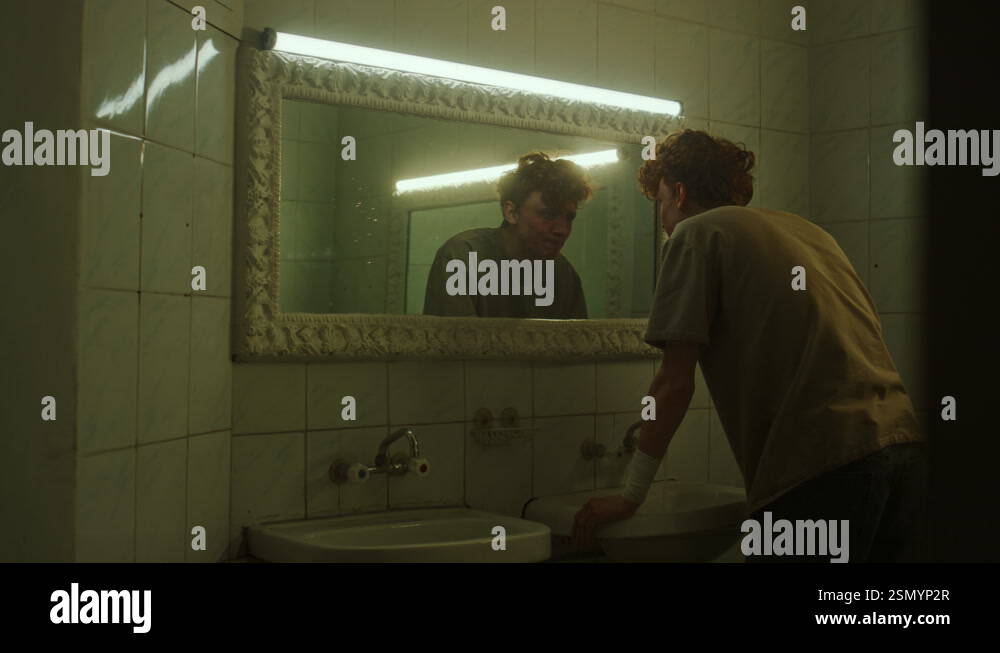 Crying Young Man Washing Face in front of Mirror and Wiping Nose Stock ...