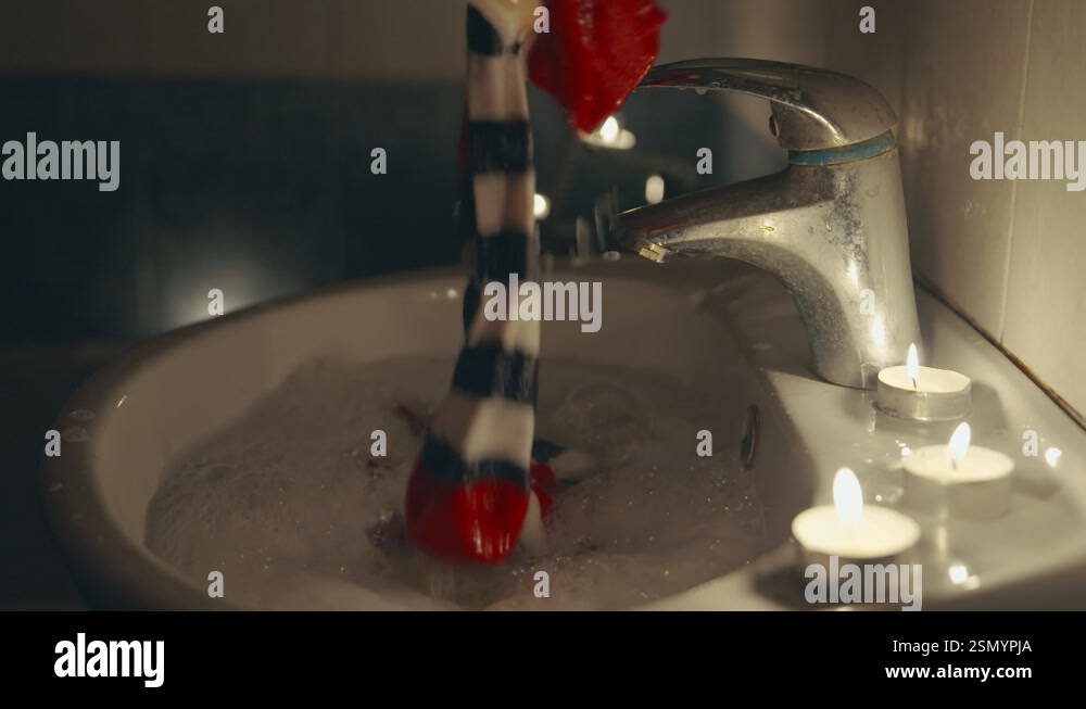 Candlelit Sink: Striped Socks Hand-Washing Close-Up. Energy-Saving ...