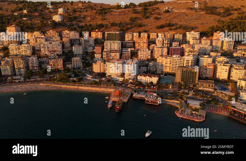 Golden hour aerial view of the Saranda coastline with beaches, boats ...