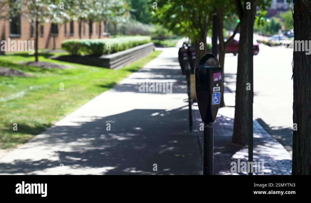 Rack focus of multiple handicap parking meters in a downtown uban ...