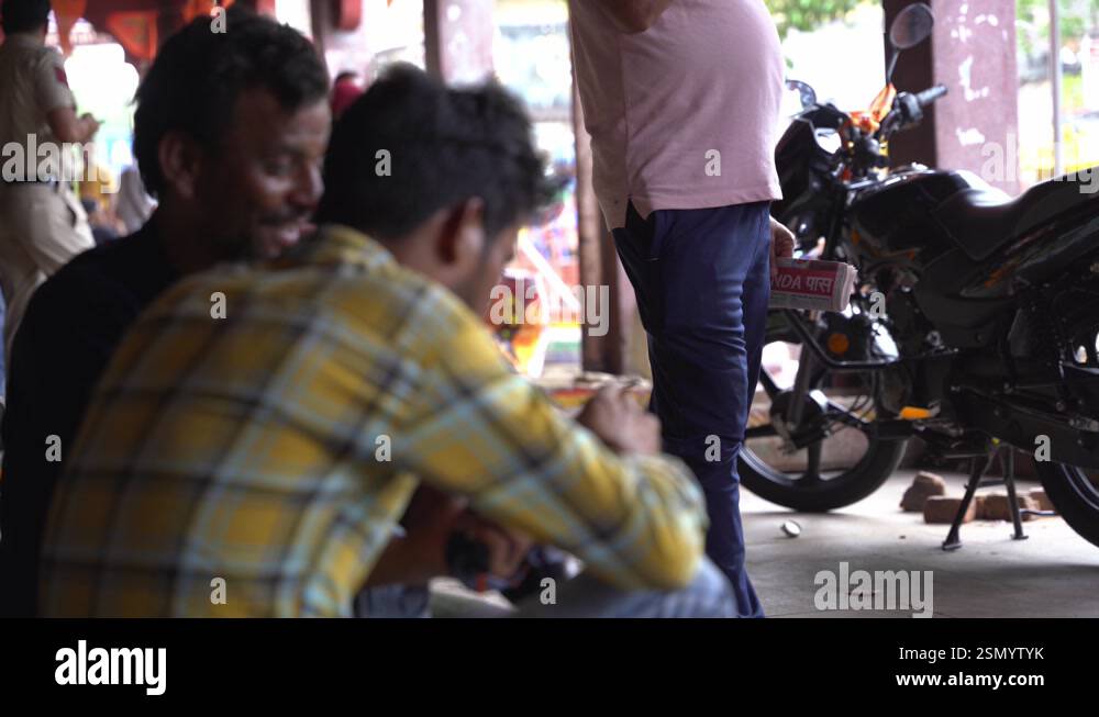 New Delhi, India - 09/06/2024: Two Indian men using smartphones in ...