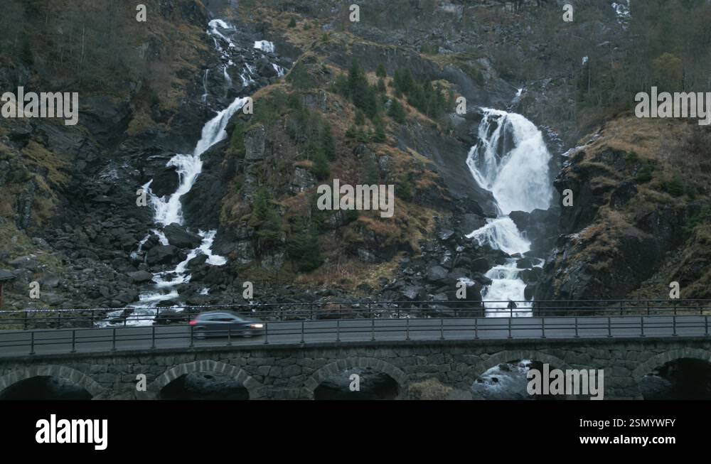 Cars crossing a stone bridge with a stunning view of the twin ...