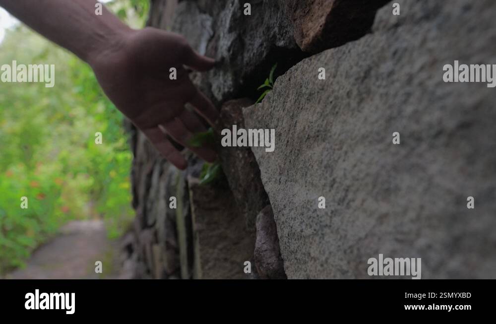 Lonely Person Walking While Touching and Caressing Stone Rock Wall In ...