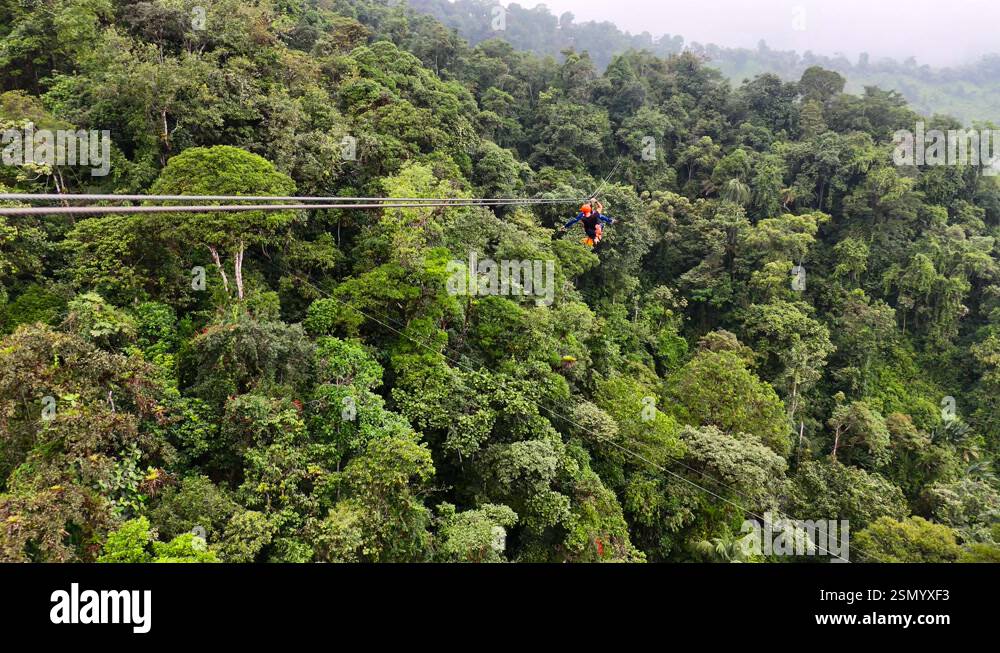 Mindo, Ecuador - 09/08/2024: Two Persons Sliding Along Zip Line Over ...