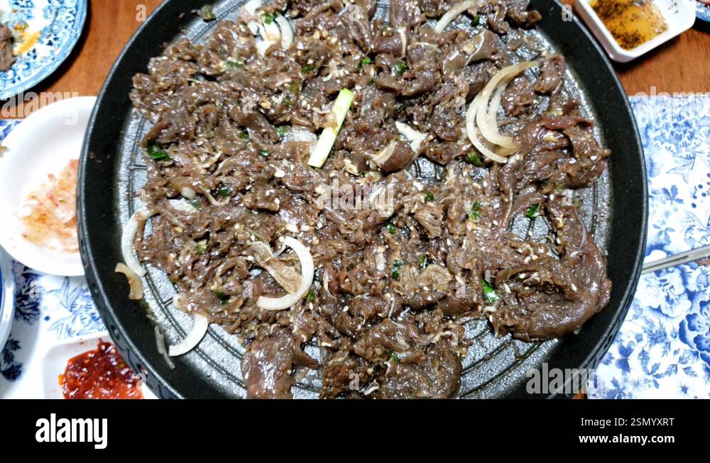 Korean Beef Bulgogi being cooked on a BBQ griddle Stock Video Footage ...