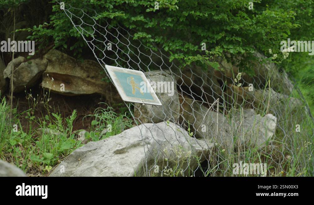 An old looking road sign showing a path for hike trail with person with ...