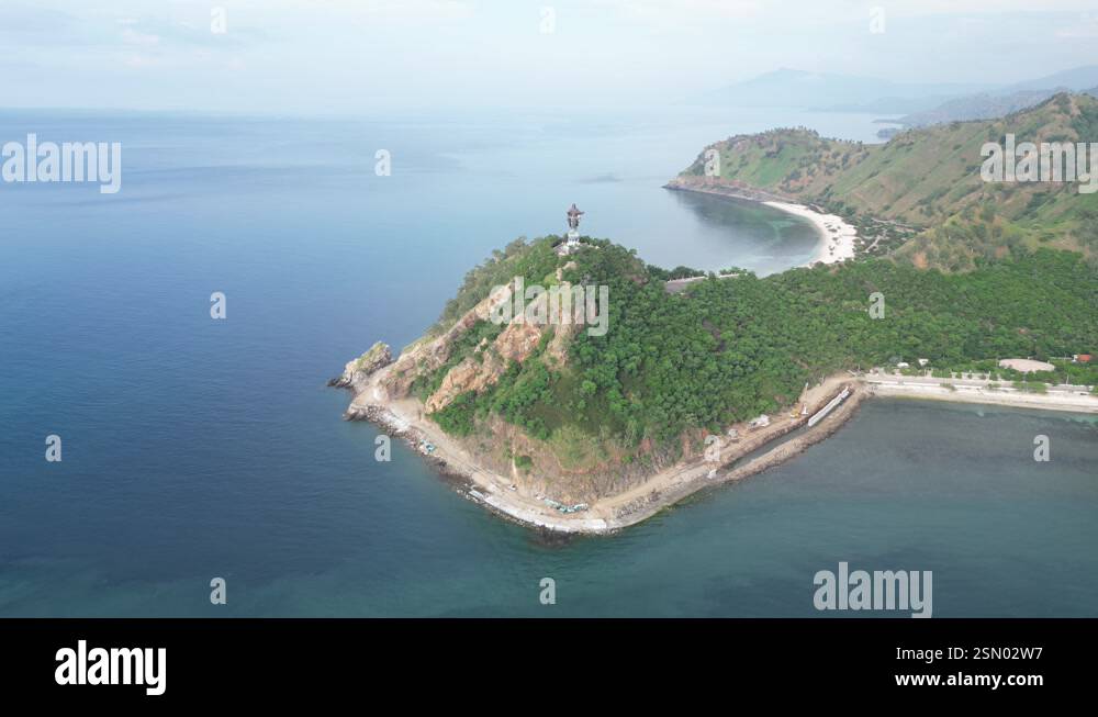Timor leste coastline with lush green hills and a small cape in the ...