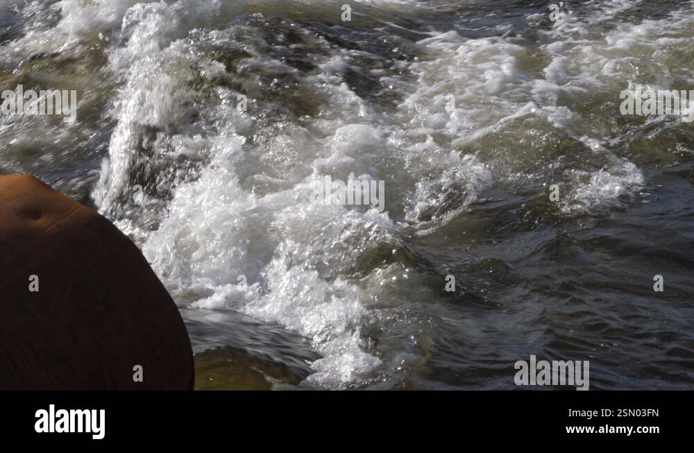 dirty waste water flows from a pipe into a river polluting and ...
