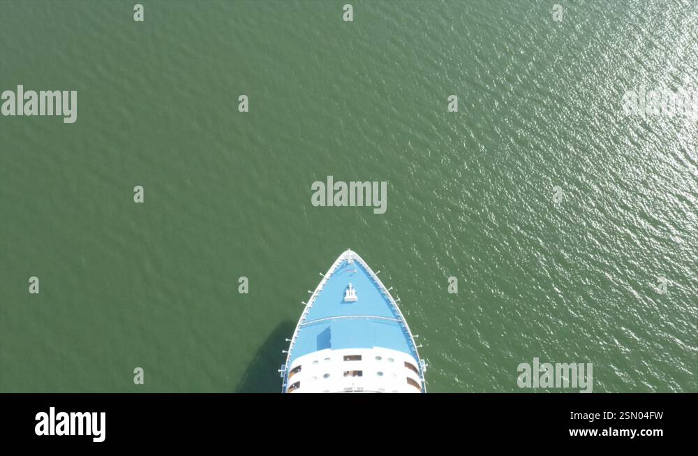 Luxury cruise ship making way ahead. Static top down aerial view of ...