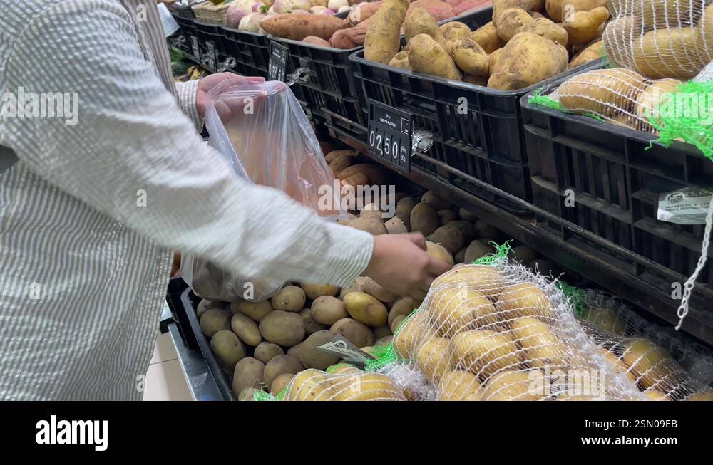Female buying a potato from store. Doha, Qatar 14-09-2024 Stock Video ...