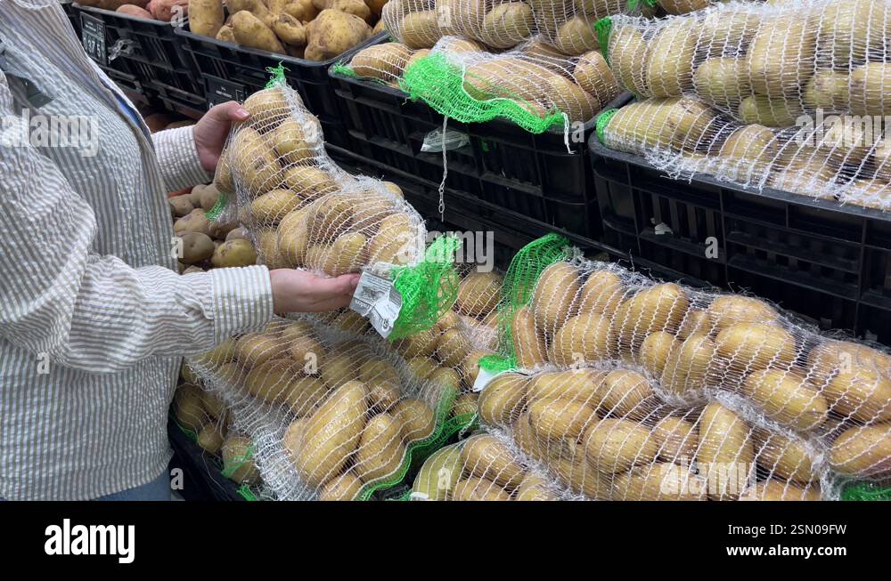 Female buying a potato bag. Grocery shopping market. Doha, Qatar 14-09 ...