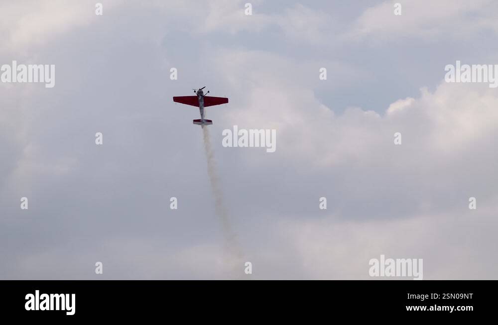 A pilot flies an aerobatic propeller plane in the sky Stock Video ...