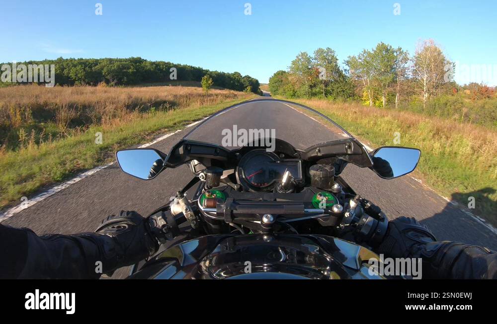 Biker racing his motor bike during summer journey. Point of view of a ...