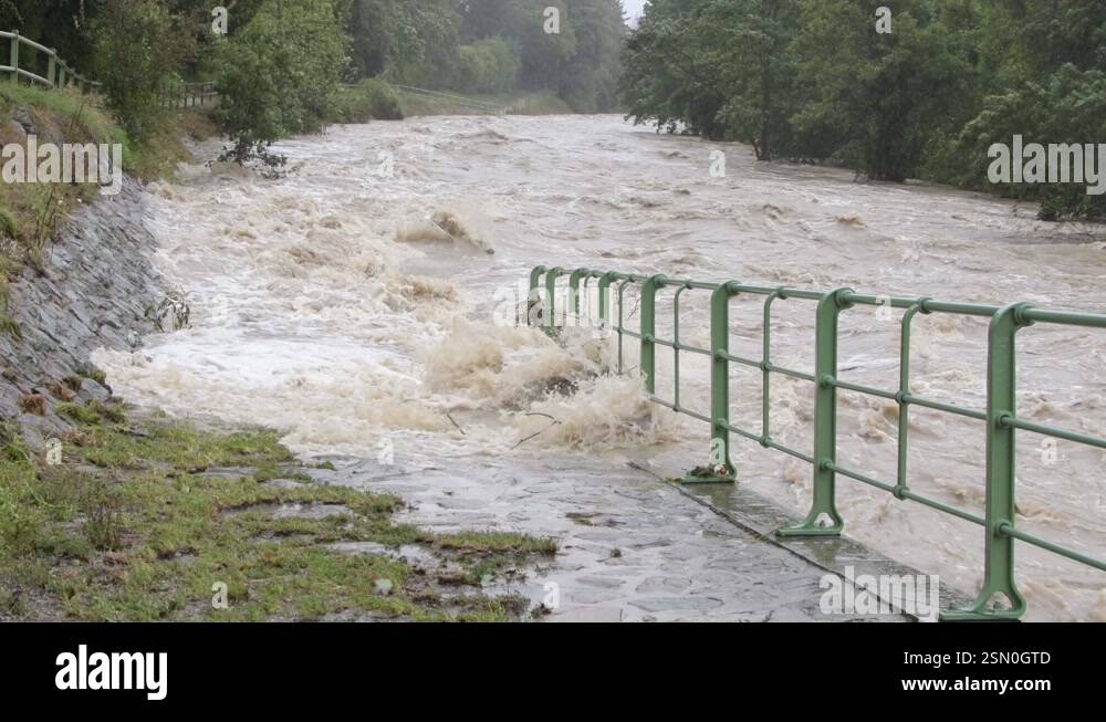 The river overflowed its banks during the deluge and flooding and the ...