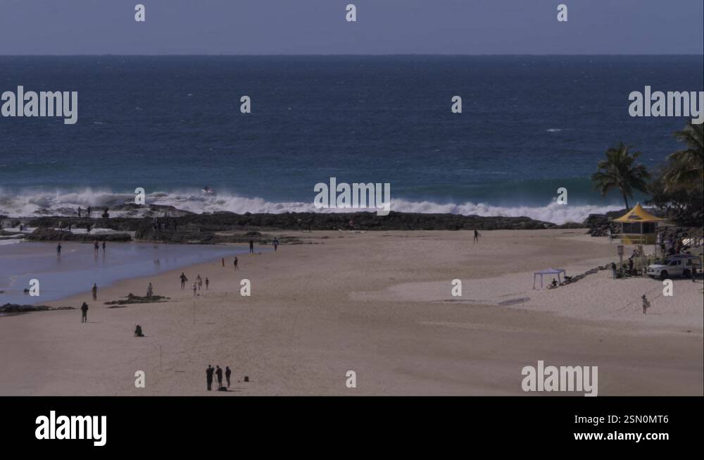 People At Snapper Rocks During Summer With Waves Breaking On Rocky ...