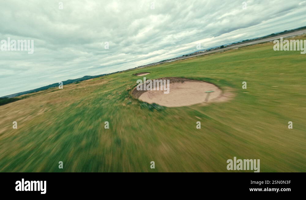 FPV drone flyover green fairways on Ireland links golf course POV Stock ...