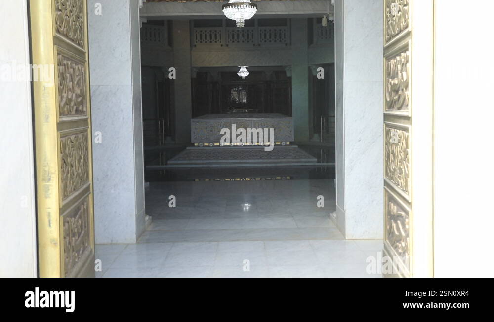 A glimpse into a grand Tunisian mausoleum entrance with ornate details ...