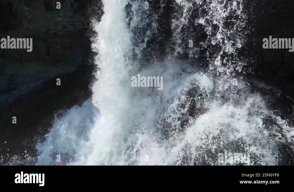 With a mesmerizing dance, the water falls, hitting the massive pebbles ...