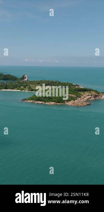 A small island featuring sandy beaches and dense green vegetation ...
