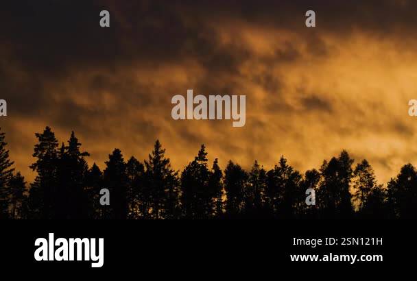 Timelapse of fascinating and scary view of sunset sky with fiery orange ...