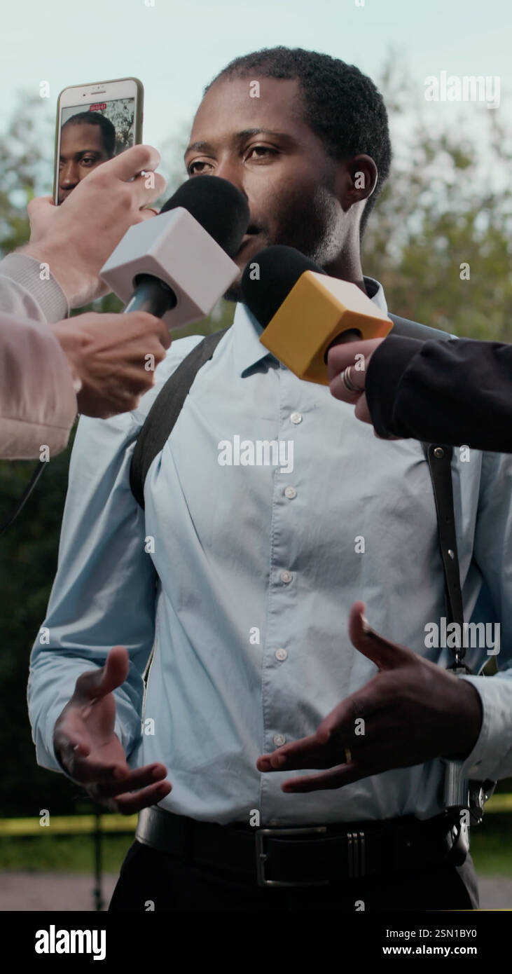 Vertical of Black Male Detective Giving Interview to Press at Crime ...