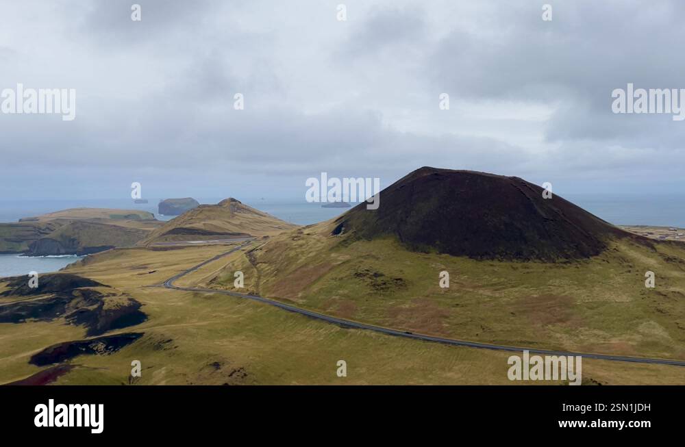 Helgafell volcano on Heimaey island in Iceland under cloudy sky, aerial ...