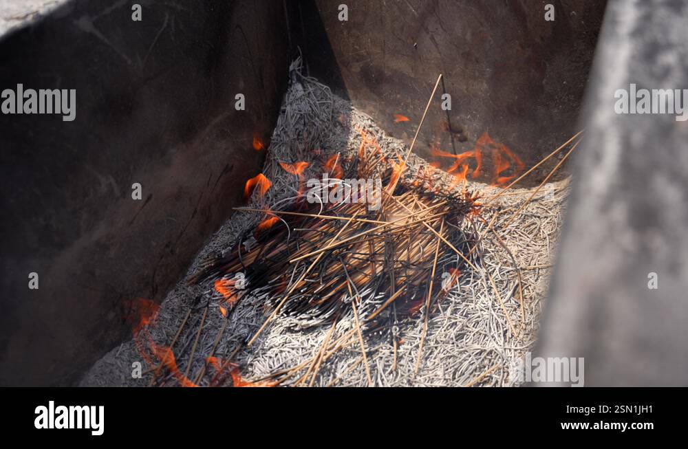 Small bonfire in incense burner as people add sticks at Lama Temple in ...