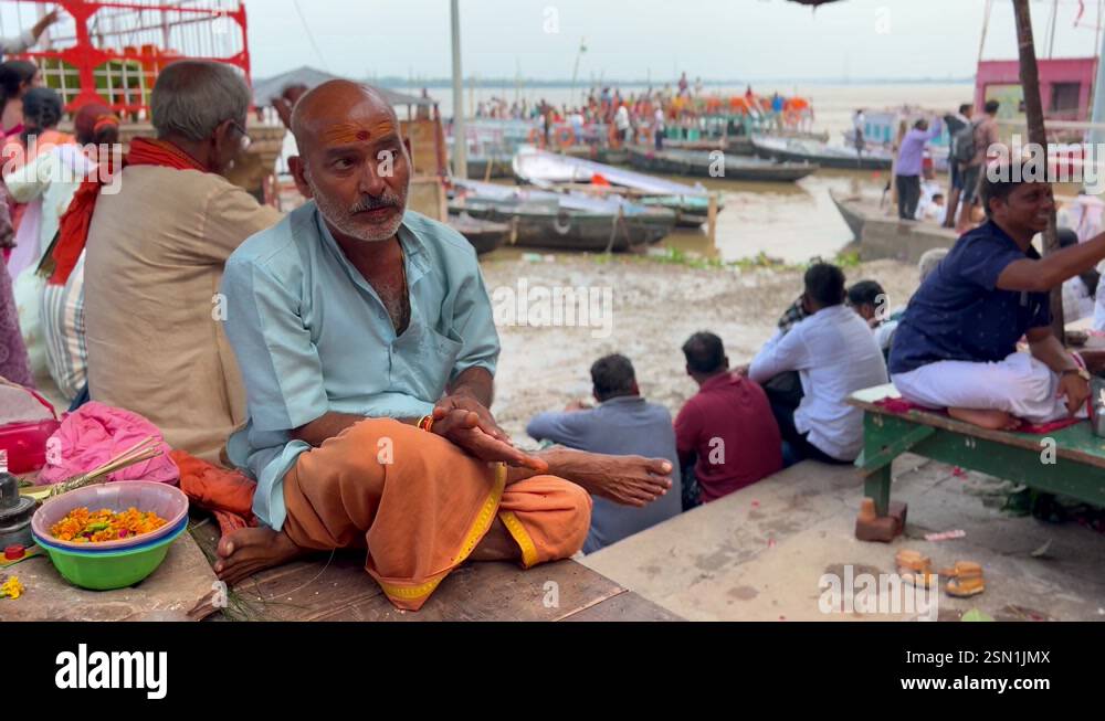 Pandit looking around, waiting for devotees at Varanasi Ghat Stock ...