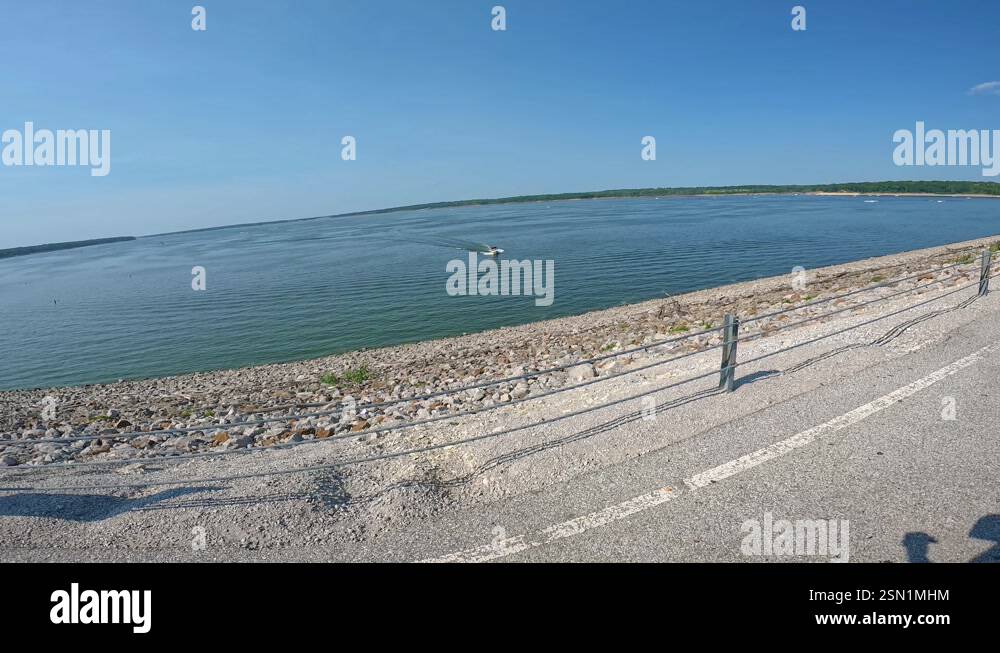 slow motion - bass boat turning away from the dam on Saylorville Lake ...