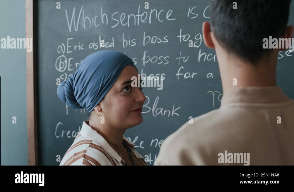 English Teacher Checking Sentence Correction Exercise on Chalkboard ...
