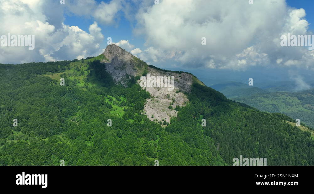 Flight over green mountain peaks. A beautiful sunny summer day at high ...