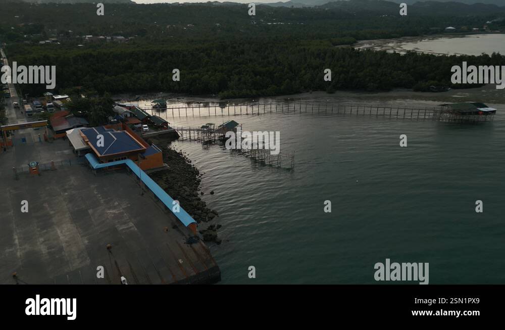 Aerial drone descends at sunrise of Taloot Argao Port in Cebu Stock ...