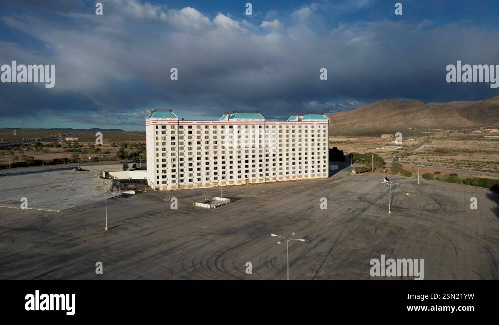 Vacant hotel building in Desert with big empty parking lots- aerial fly ...