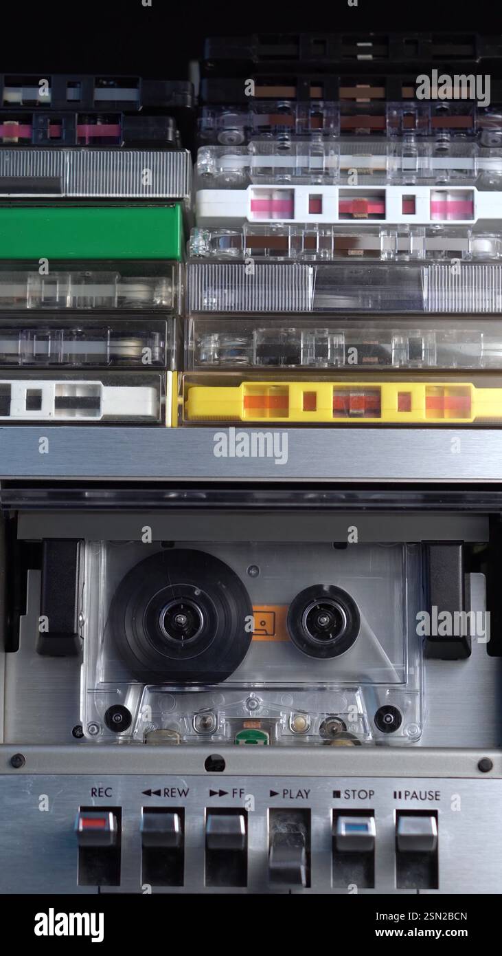 Vertical View of Hand Placing Audio Cassette in Deck With Bunch of ...