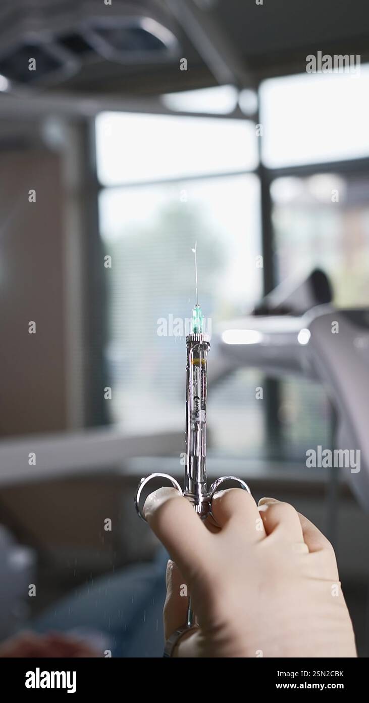 Close-up, Syringe with Anesthesia in Hand Dentist. In Background Dental ...