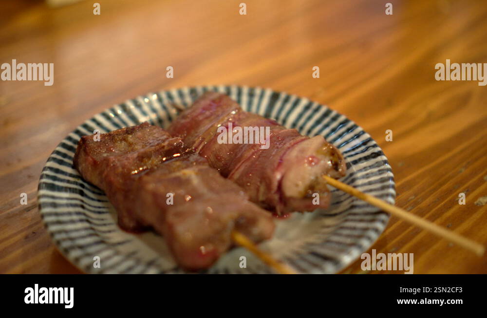 Japanese food Izakaya yakitori skewers medium rare bloody meat Stock ...