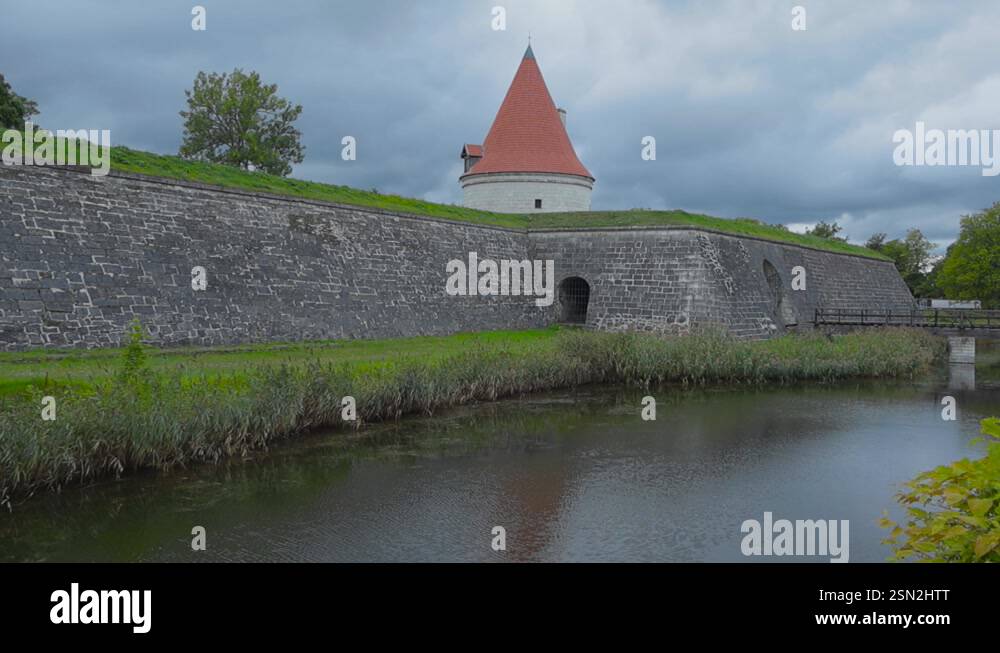 A moat filled with rippling and reflective water outside of Kuressaare ...